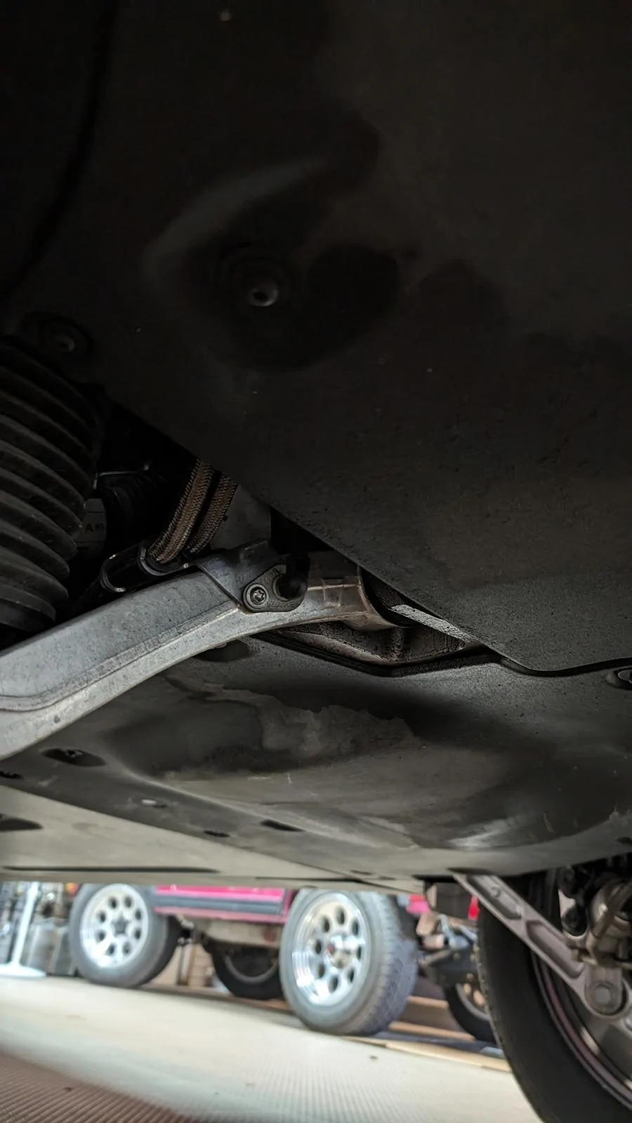 Leaking (hydraulic?) fluid above rear control arm pivot point. | Rivian ...